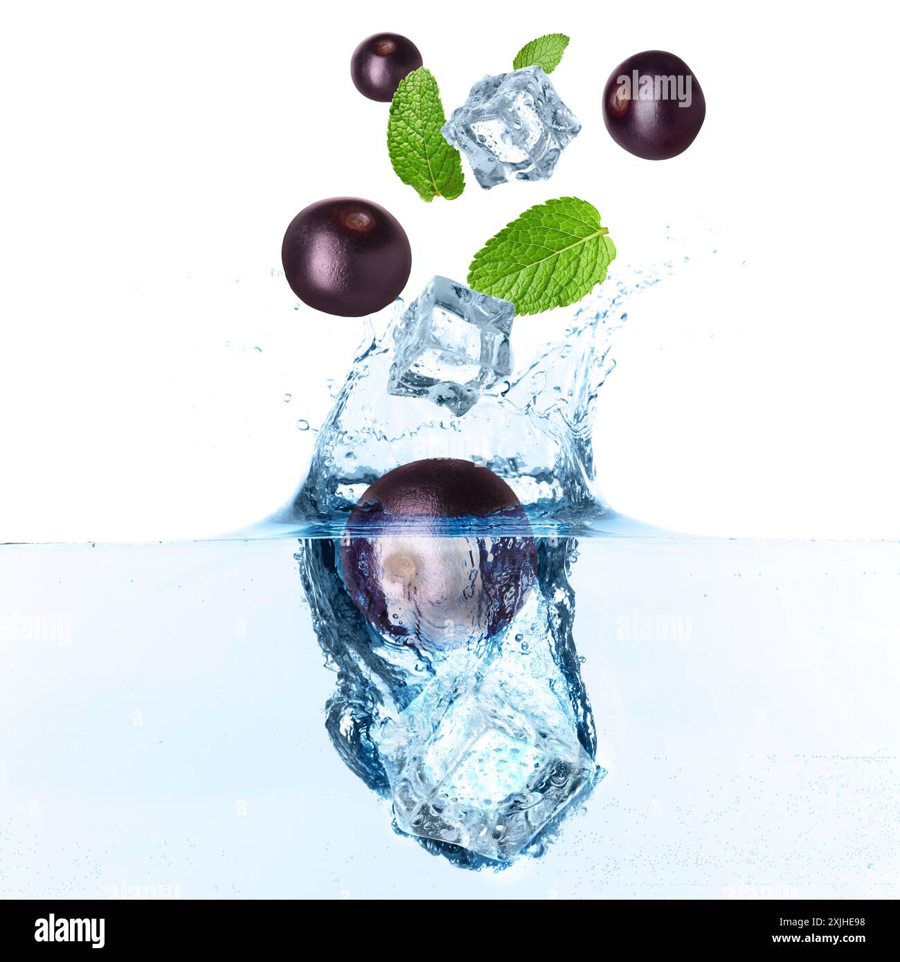 Acai berries, mint leaves and ice cubes falling into water on white ...