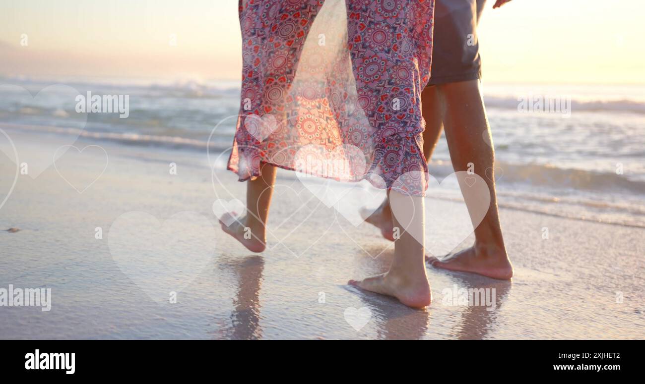 Image of hearts moving over diverse couple in love on beach in summer ...