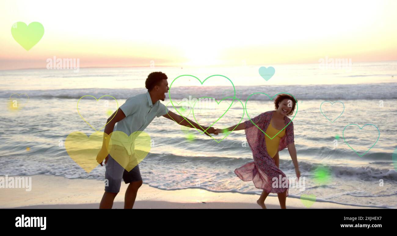 Image of hearts moving over diverse couple in love dancing on beach in ...