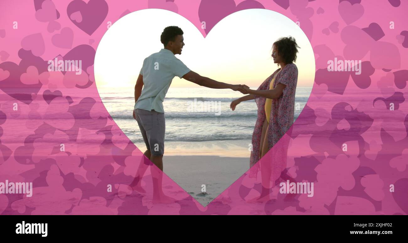 Image of hearts moving over diverse couple in love dancing on beach in ...