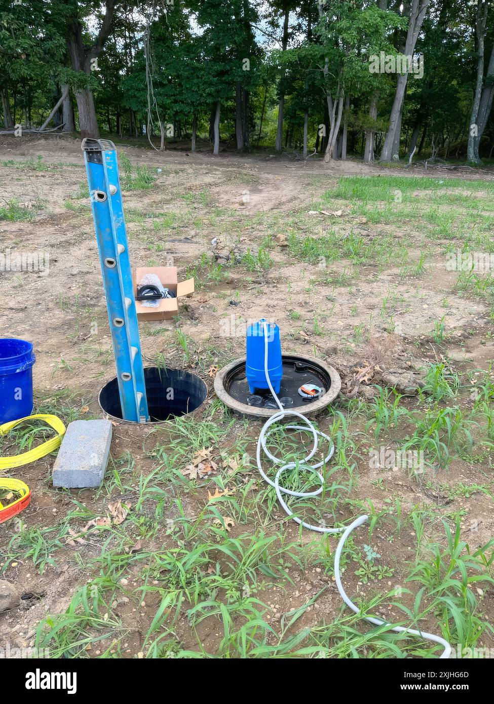 Connection between supply pump an artesian well Stock Photo - Alamy