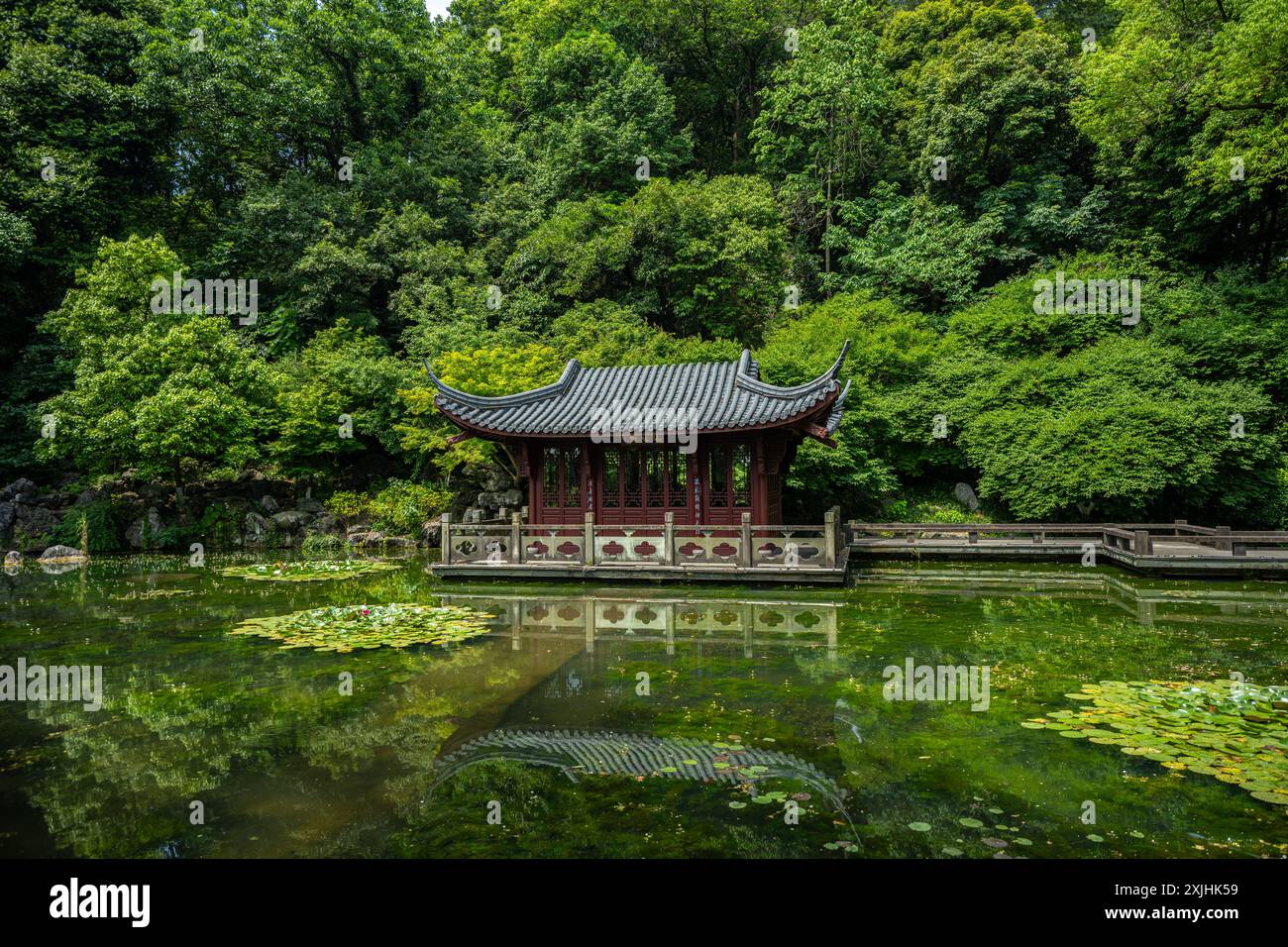 A traditional Chinese pavilion nestled in a serene garden. Wooden ...