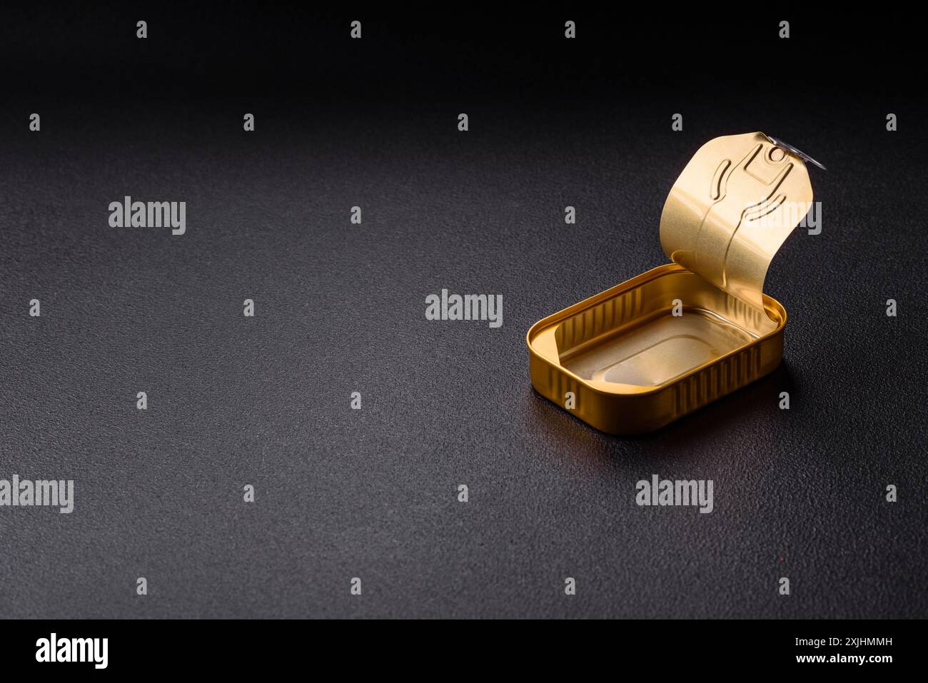 Tin or aluminum opened rectangular can of canned food with a key on a ...