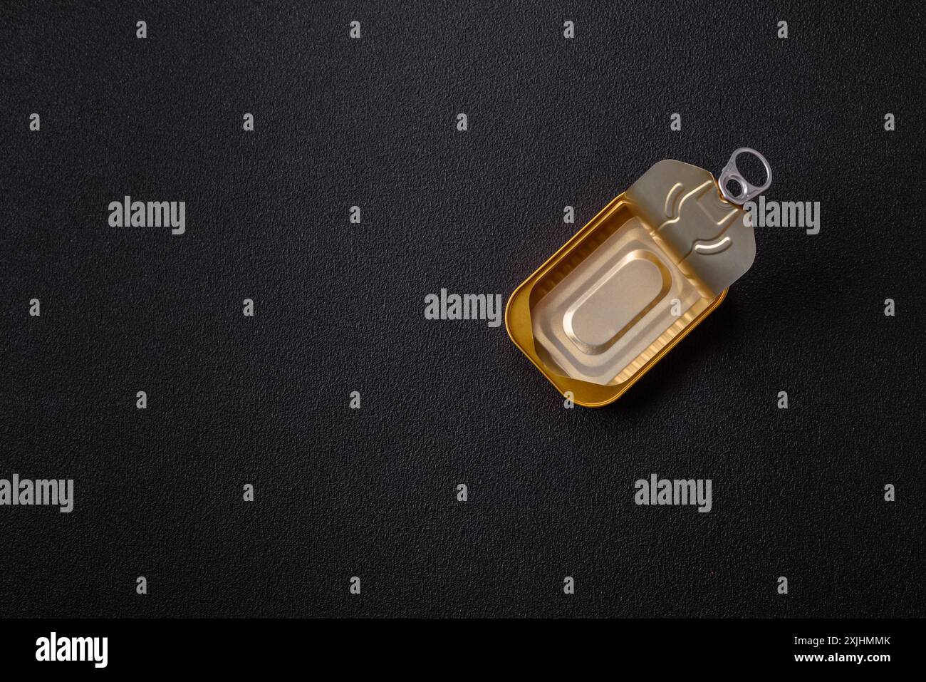 Tin or aluminum opened rectangular can of canned food with a key on a ...