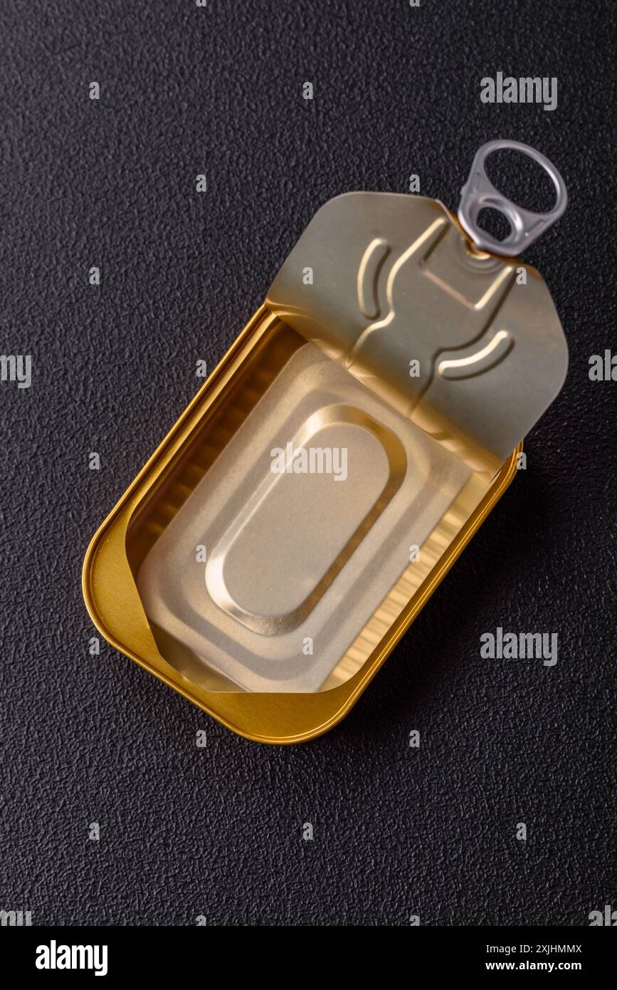 Tin or aluminum opened rectangular can of canned food with a key on a ...