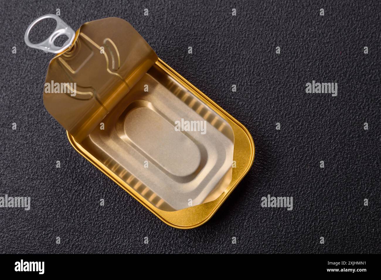 Tin or aluminum opened rectangular can of canned food with a key on a ...