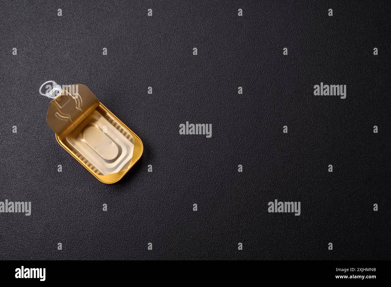 Tin or aluminum opened rectangular can of canned food with a key on a ...