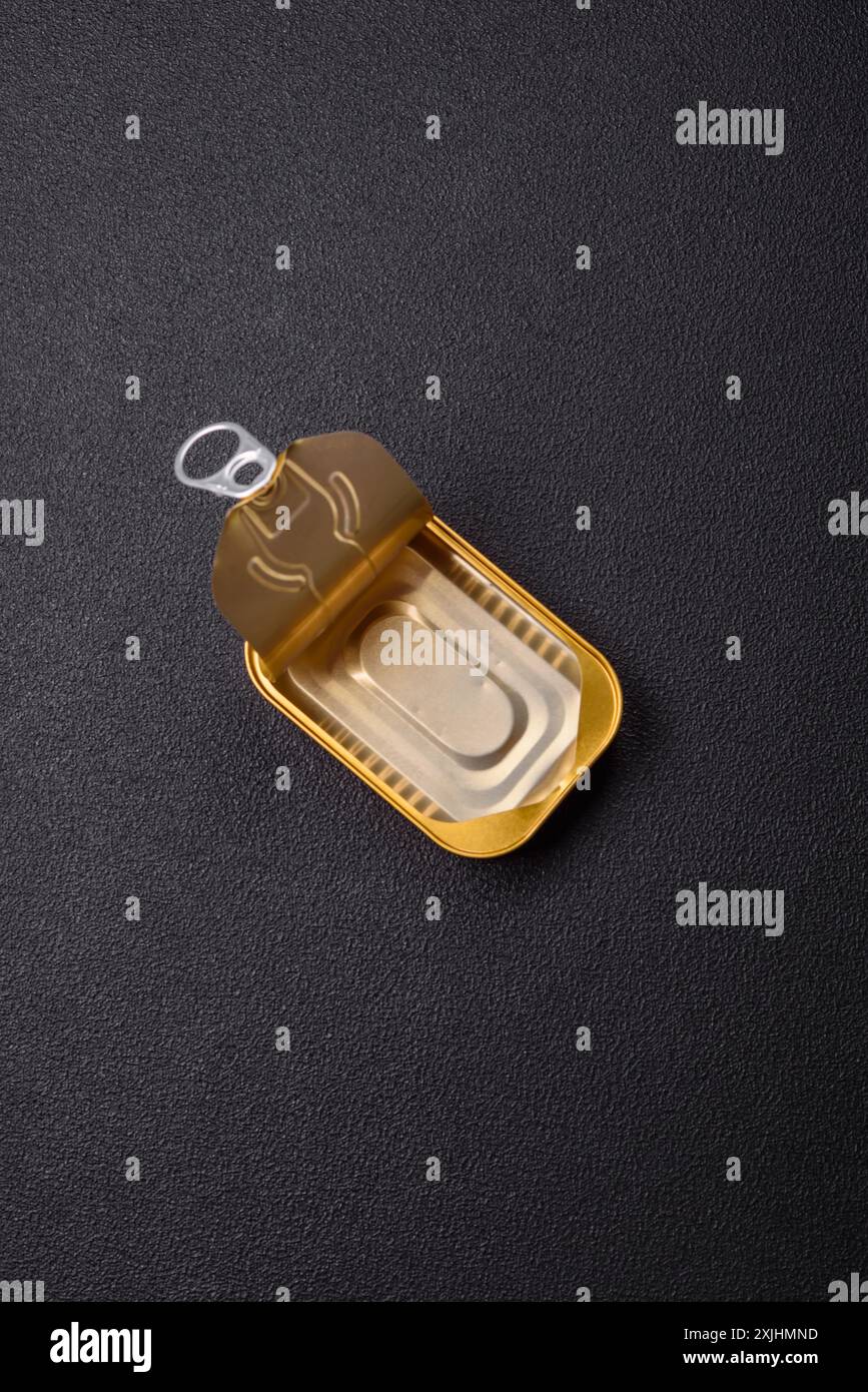 Tin or aluminum opened rectangular can of canned food with a key on a ...