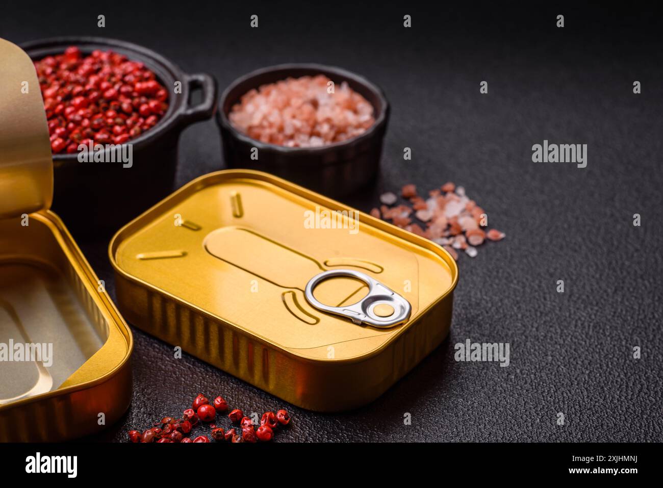 Metal can with canned meat or fish with a key to open it on a dark ...
