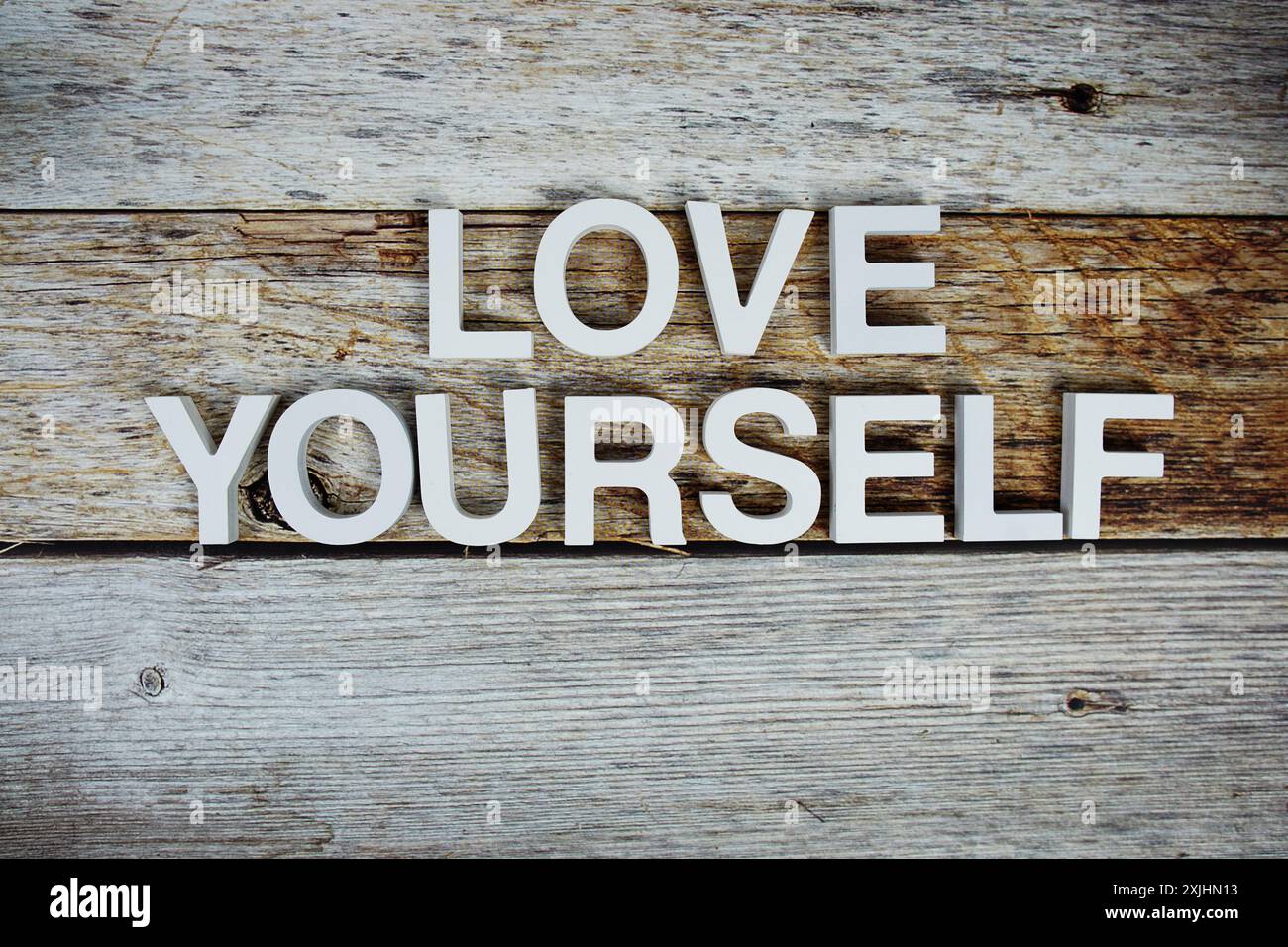 Love Yourself alphabet letters on wooden background Stock Photo - Alamy