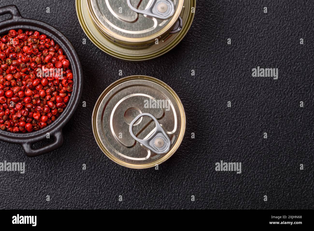 Metal can with canned meat or fish with a key to open it on a dark ...