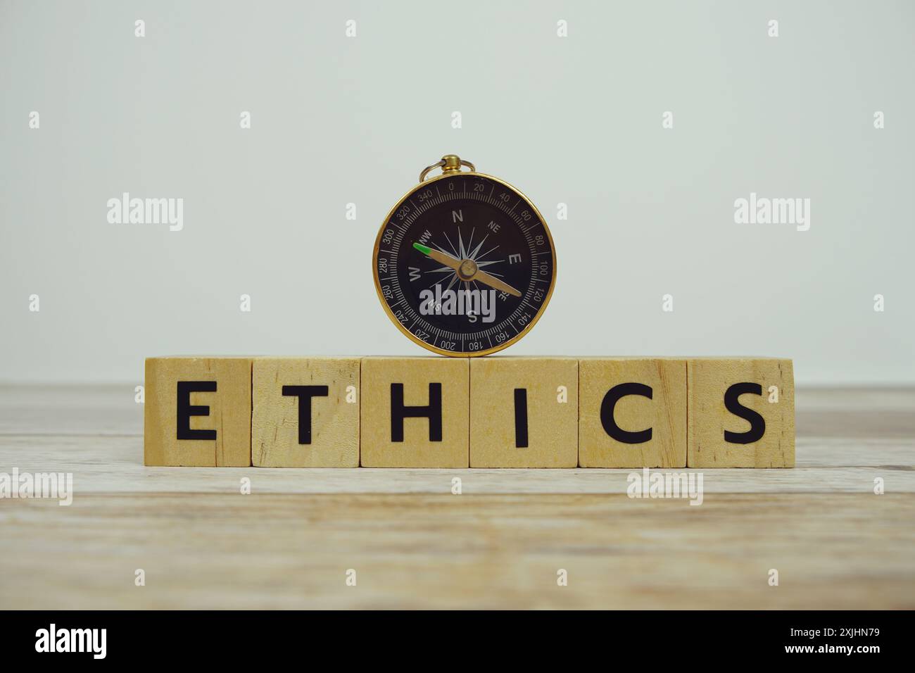 Compass with wooden blocks alphabet letters ETHICS on wooden background ...