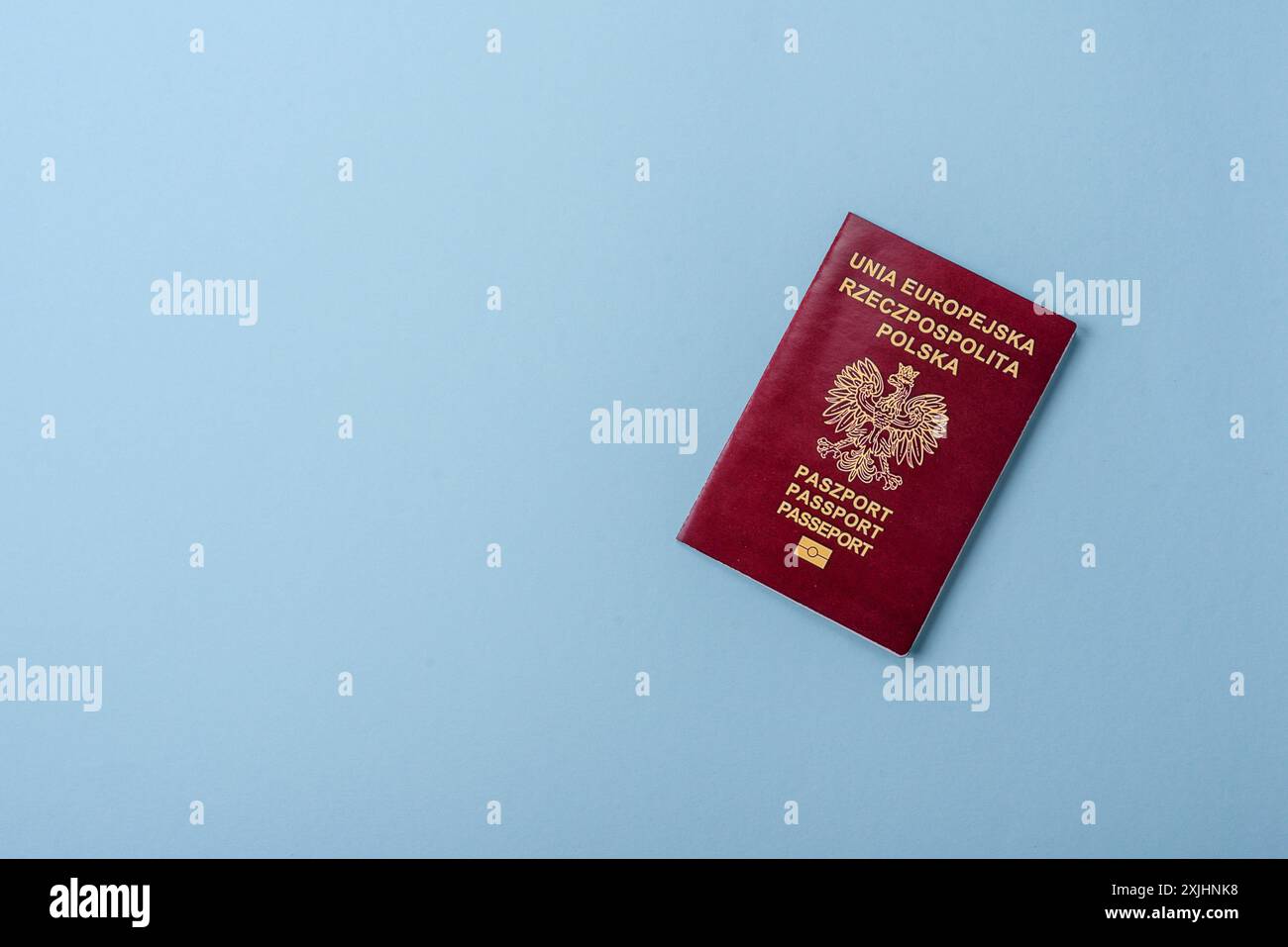 Physical paper international passport of a Polish citizen on a blue ...