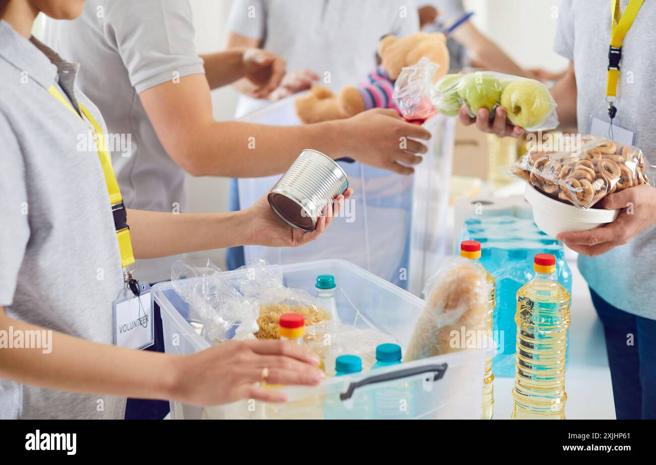 Food bank distribution table, volunteer group working in charitable ...