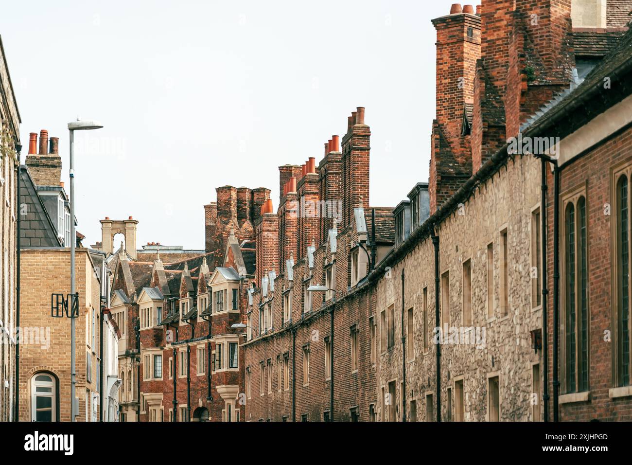 A narrow street in Cambridge, UK lined with brick buildings and ...