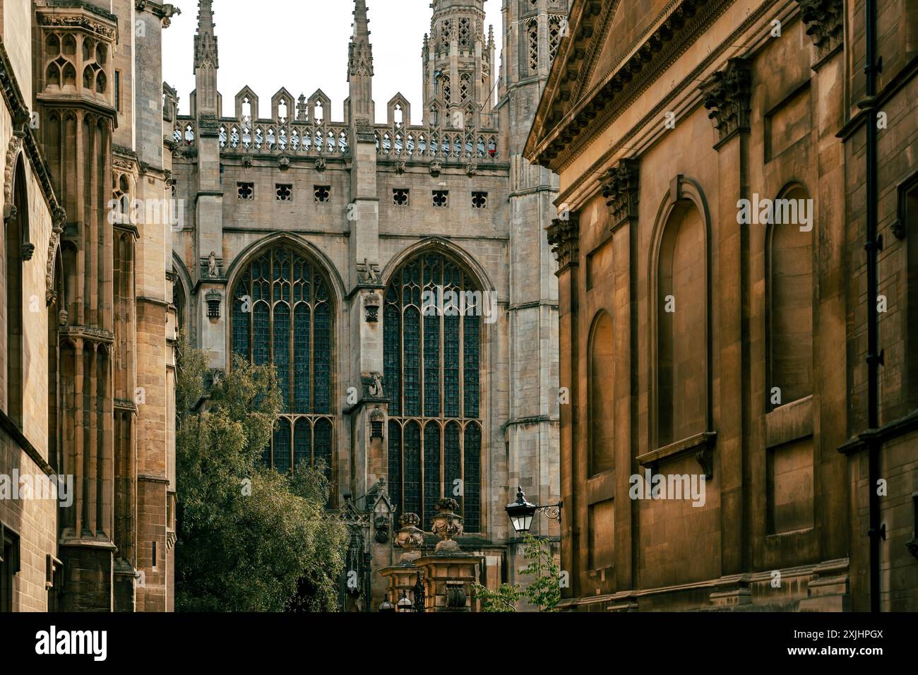 A narrow alleyway in Cambridge, UK, framed by historic stone buildings ...