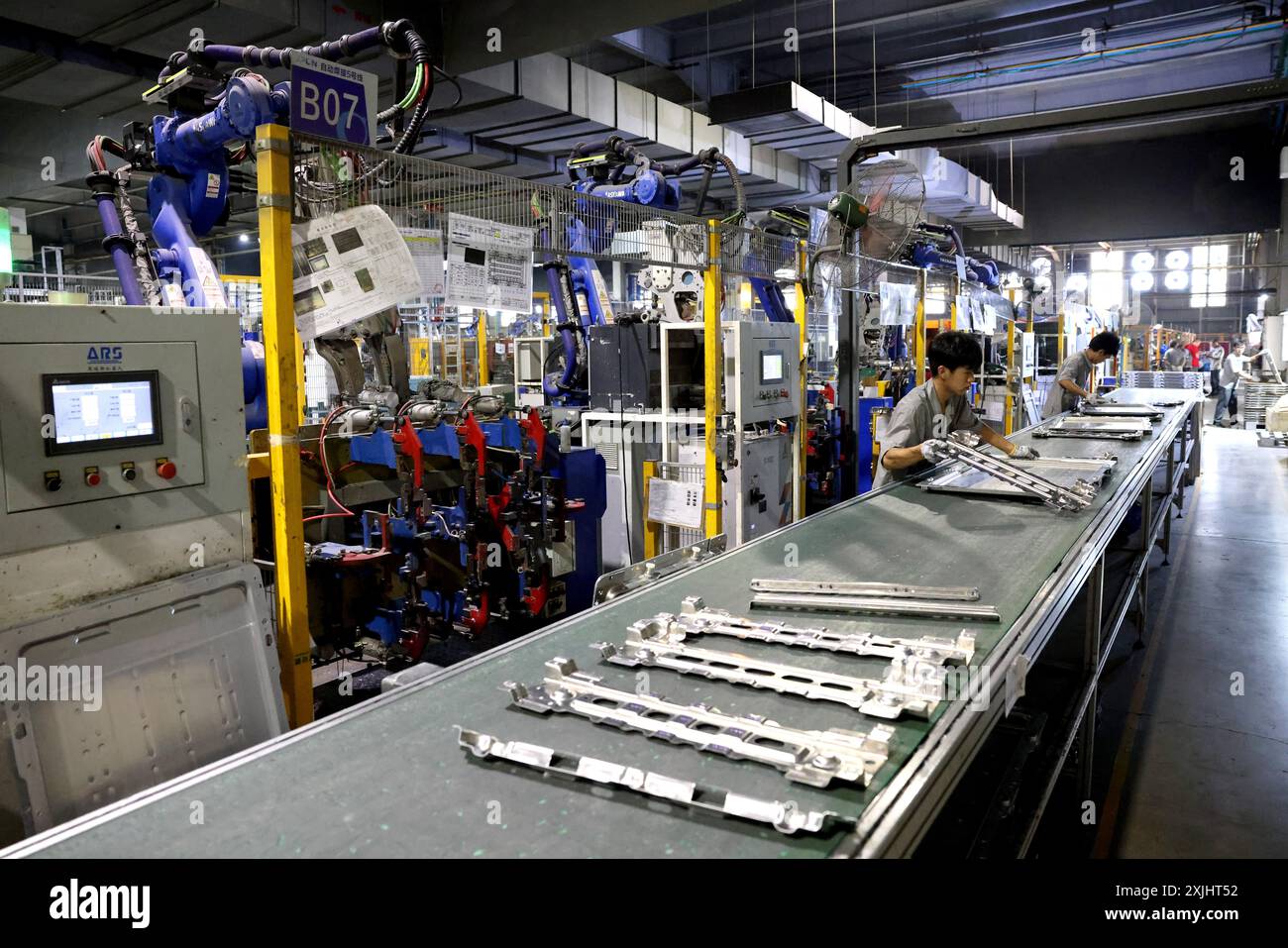 FUZHOU, CHINA - JULY 17, 2024 - Workers work with automatic welding ...