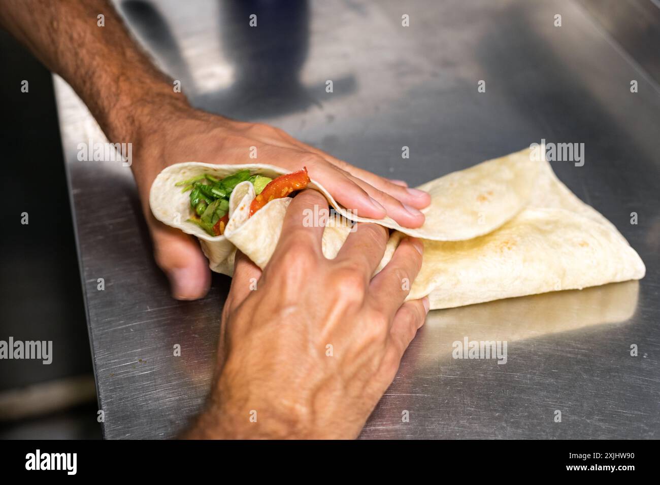 Burrito being made in a kitchen Stock Photo - Alamy