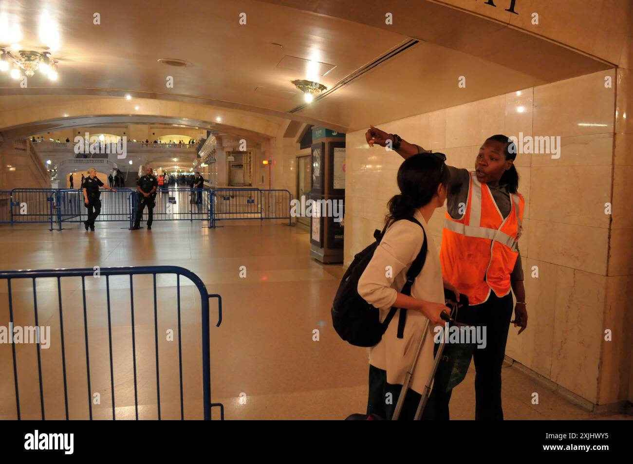 A transit worker gives directions to a pedestrian in Grand Central ...