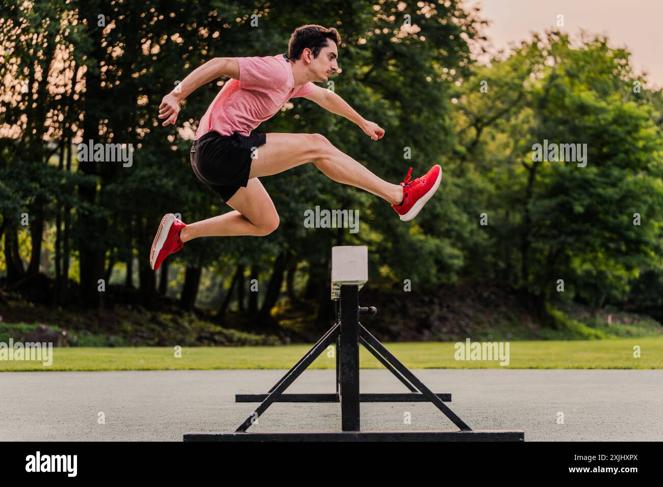 Runner jumping a hurdle hi-res stock photography and images - Alamy