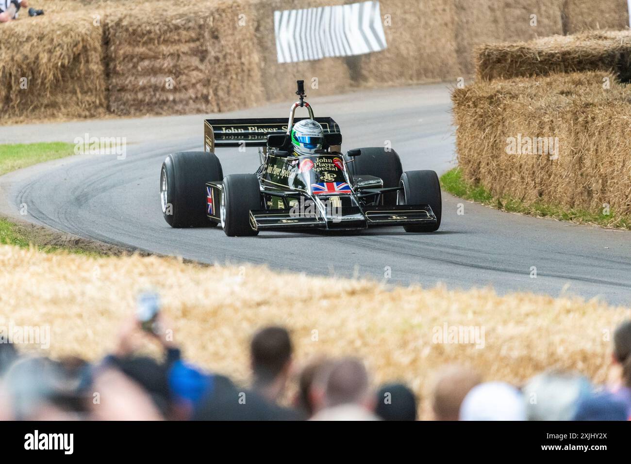 1976 Lotus-Cosworth 77 Formula 1 racing car driving up the hill climb track at the Goodwood ...