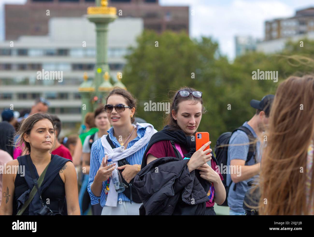People cross Westminster Bridge in London, as many tourists are ...