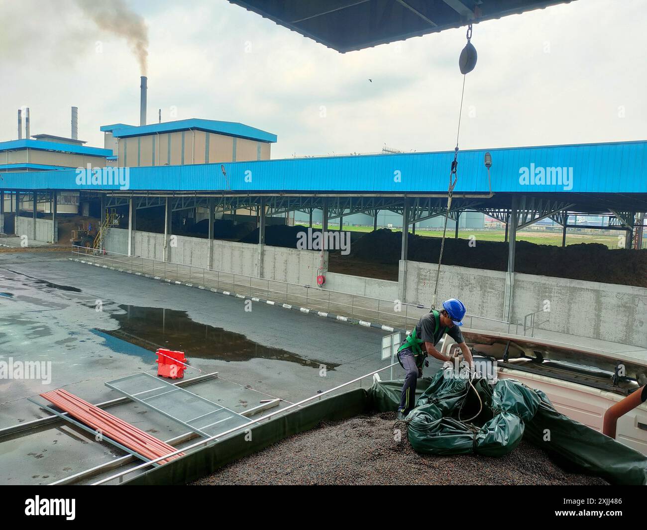A truck driver uses a safety harness that is attached to a Self ...