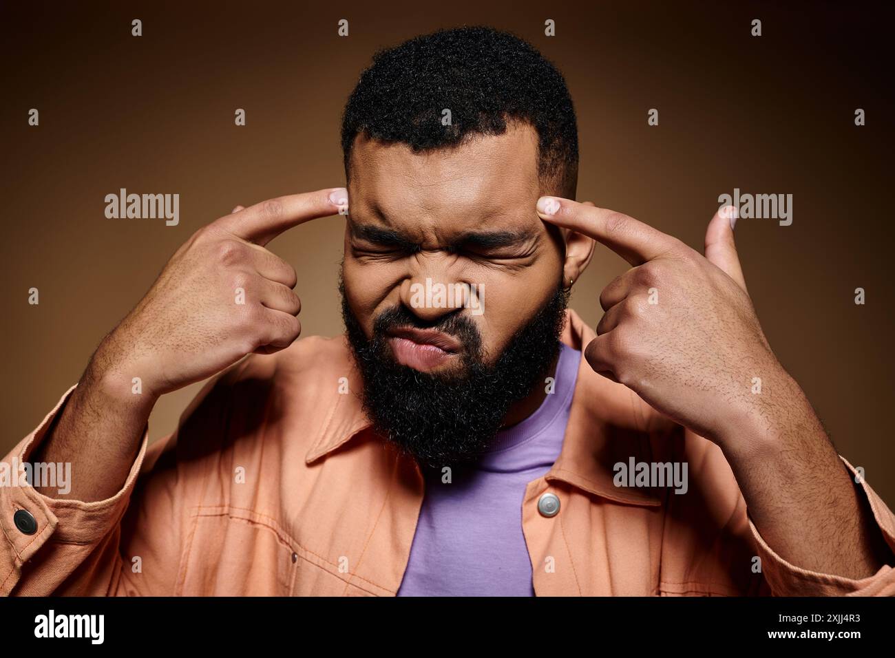 Stylish African American man with a beard in a bold purple shirt ...