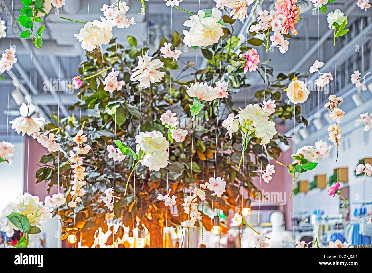 decoration with flowers in florist style in a clothing store. Modern ...