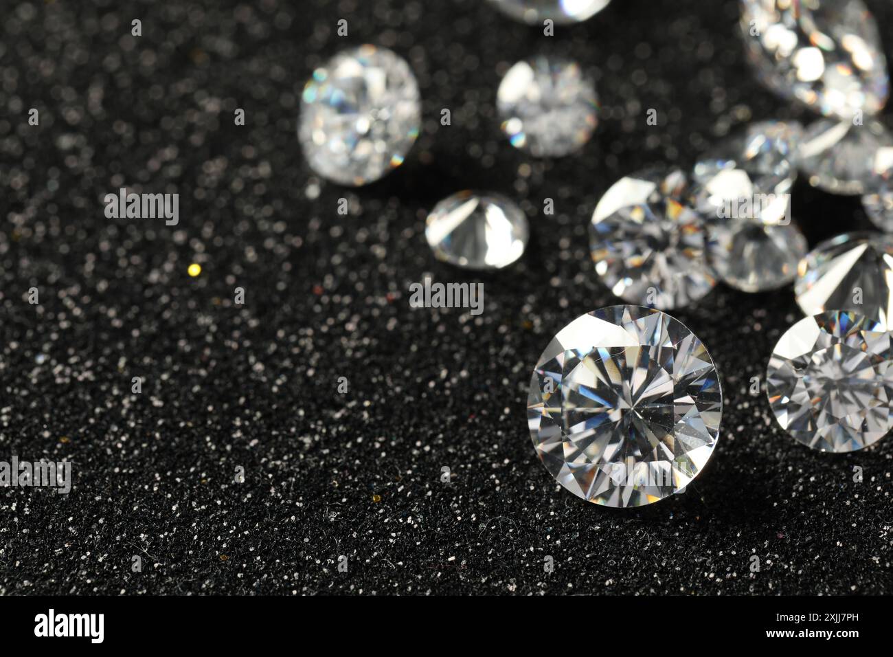 Beautiful dazzling diamonds on dark shiny background, closeup. Space ...