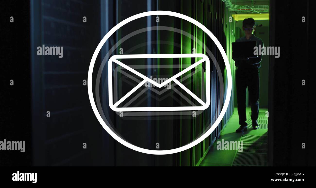 Image of envelope email icon over male technician with laptop in dark ...