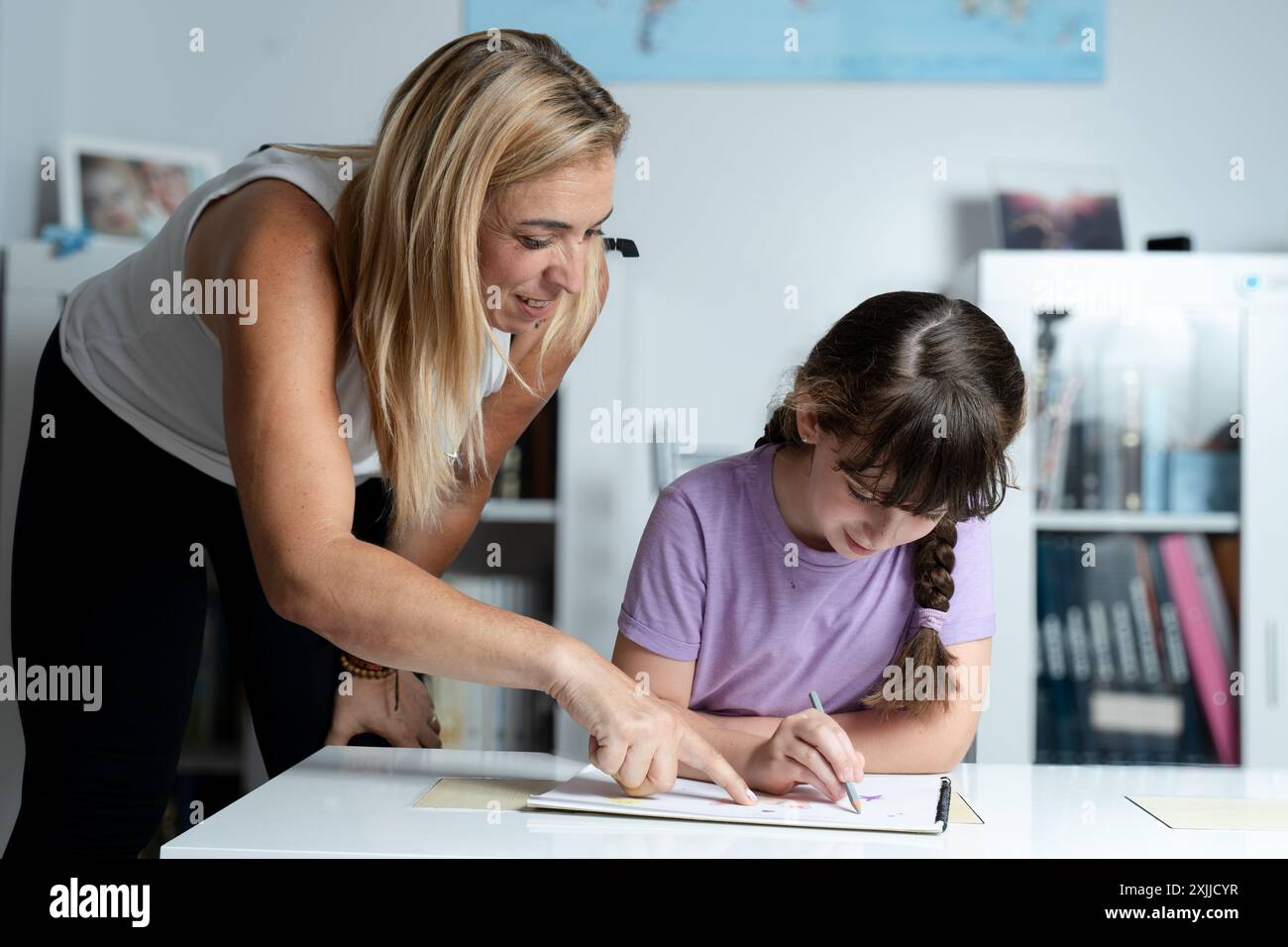mother helping her daughter with her homework Stock Photo - Alamy