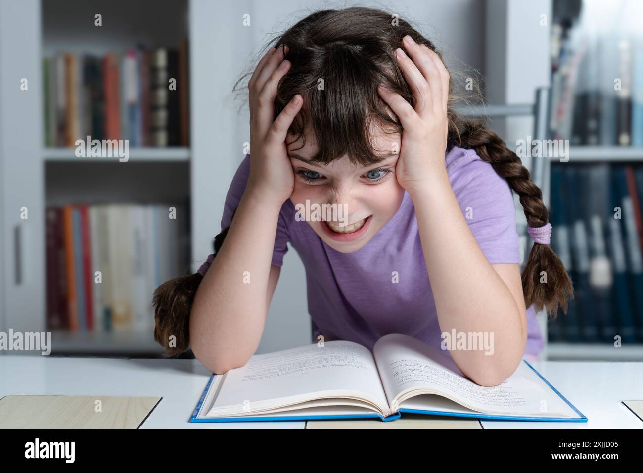 girl with hands on her head bored of studying Stock Photo - Alamy