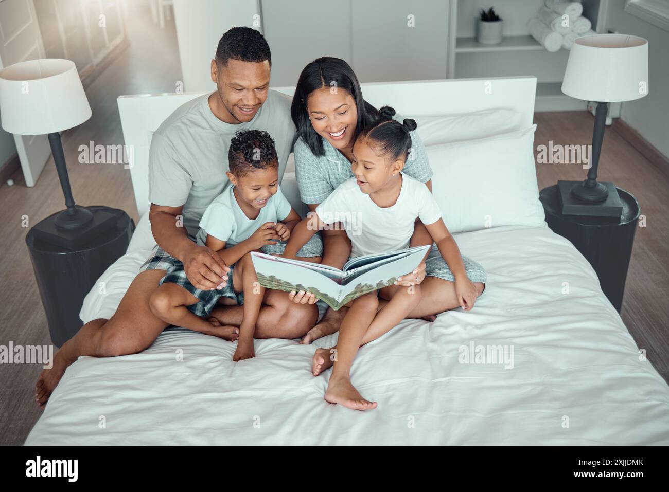 Kids, parents and reading a book in bedroom for storytelling, language ...