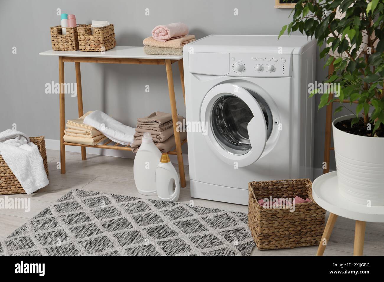Washing machine, detergents, basket, laundry, houseplant and storage ...