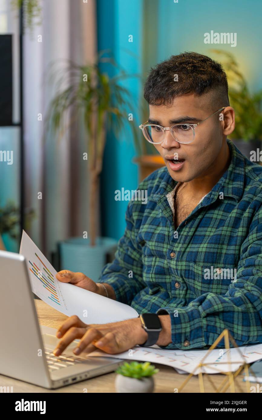 Indian freelancer man accountant working with financial graph documents ...