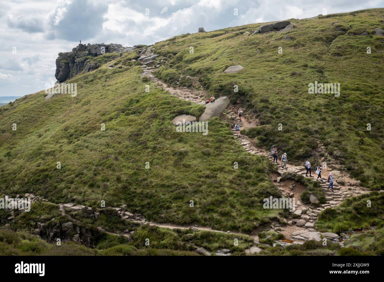 A group of women walkers carry babies and infants and descend the steps ...