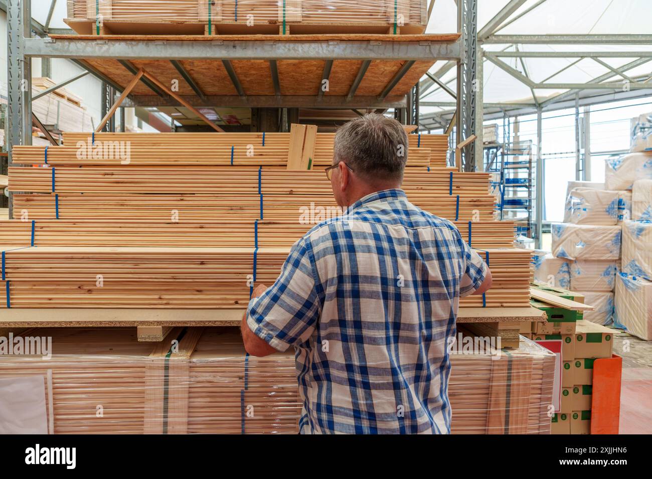 Senior Man Selecting Lumber at a Hardware Store Stock Photo - Alamy