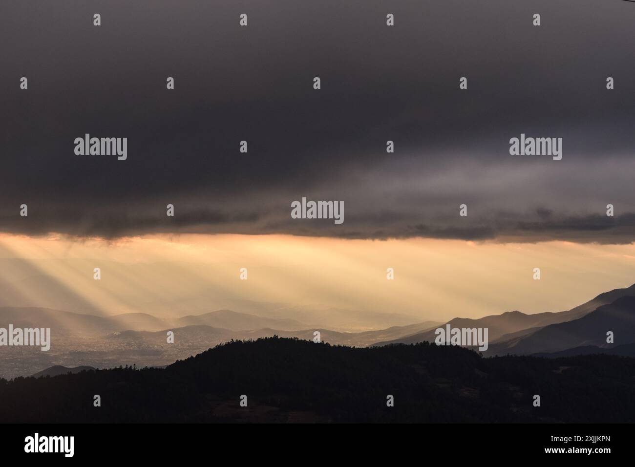 View of sunset light with dark sky over mountains of Oaxaca, MÃ©xico ...