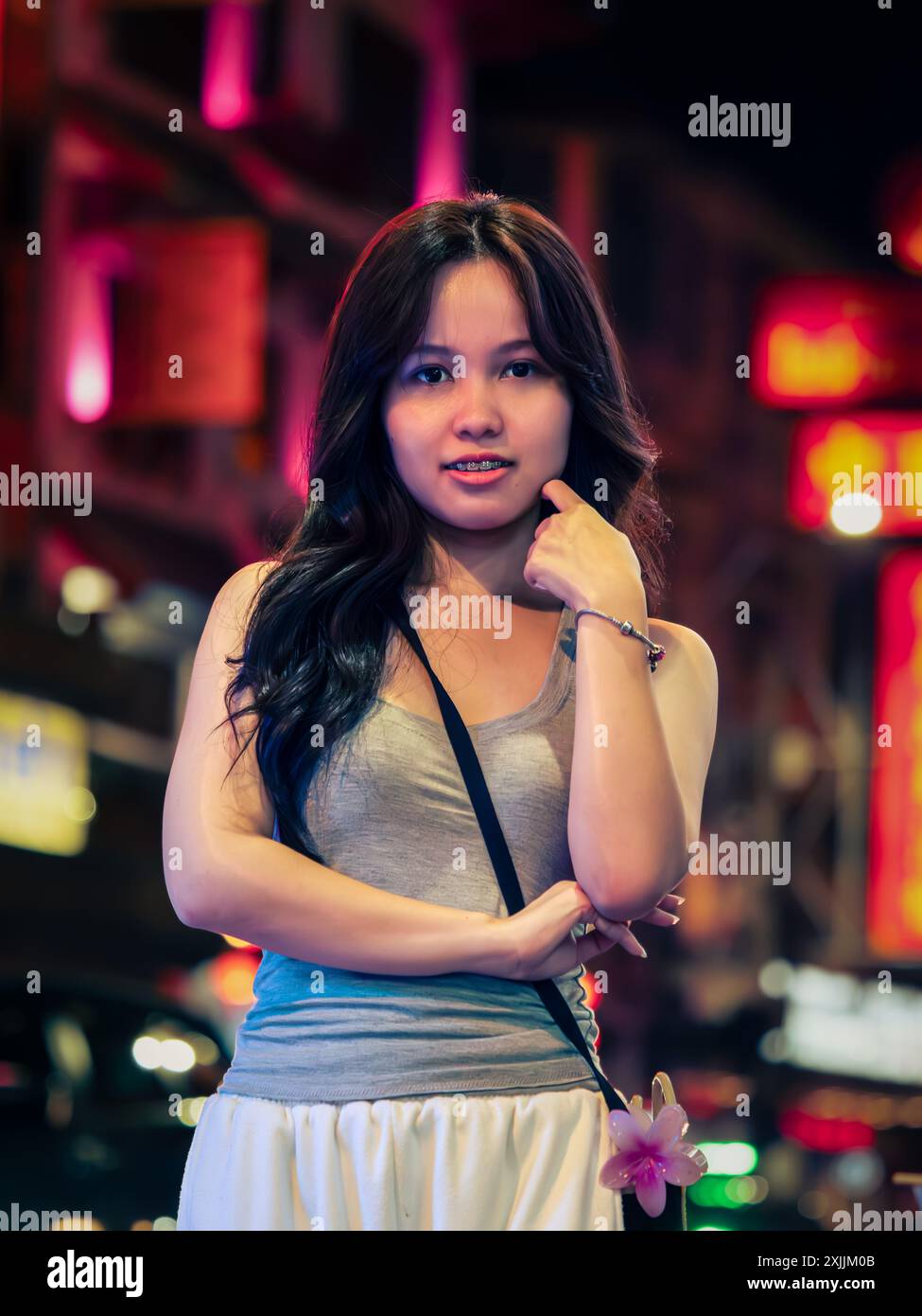 Young Woman Posing in Front of Neon Signs in Southeast Asia at Night ...