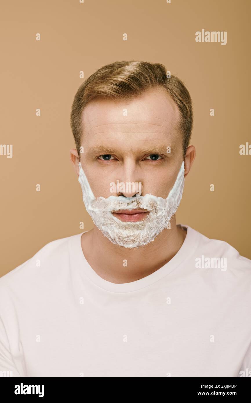 A bearded man in casual attire carefully shaves off his beard Stock ...