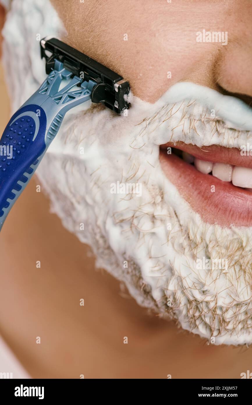 Bathroom man in the bathroom shaving with a razor hi-res stock ...