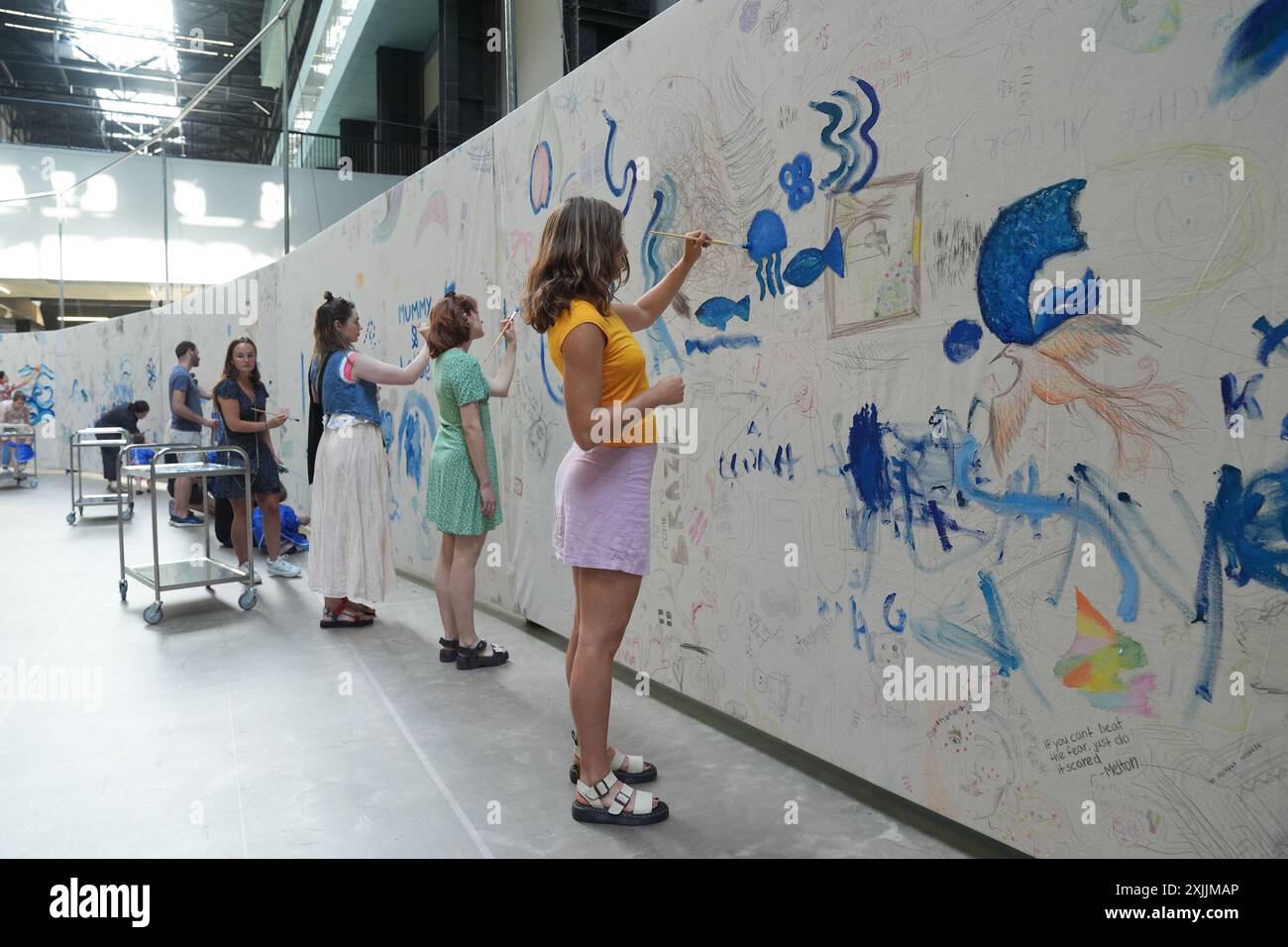 People painting during a photo call for UNIQLO Tate Play: Oscar Murillo ...