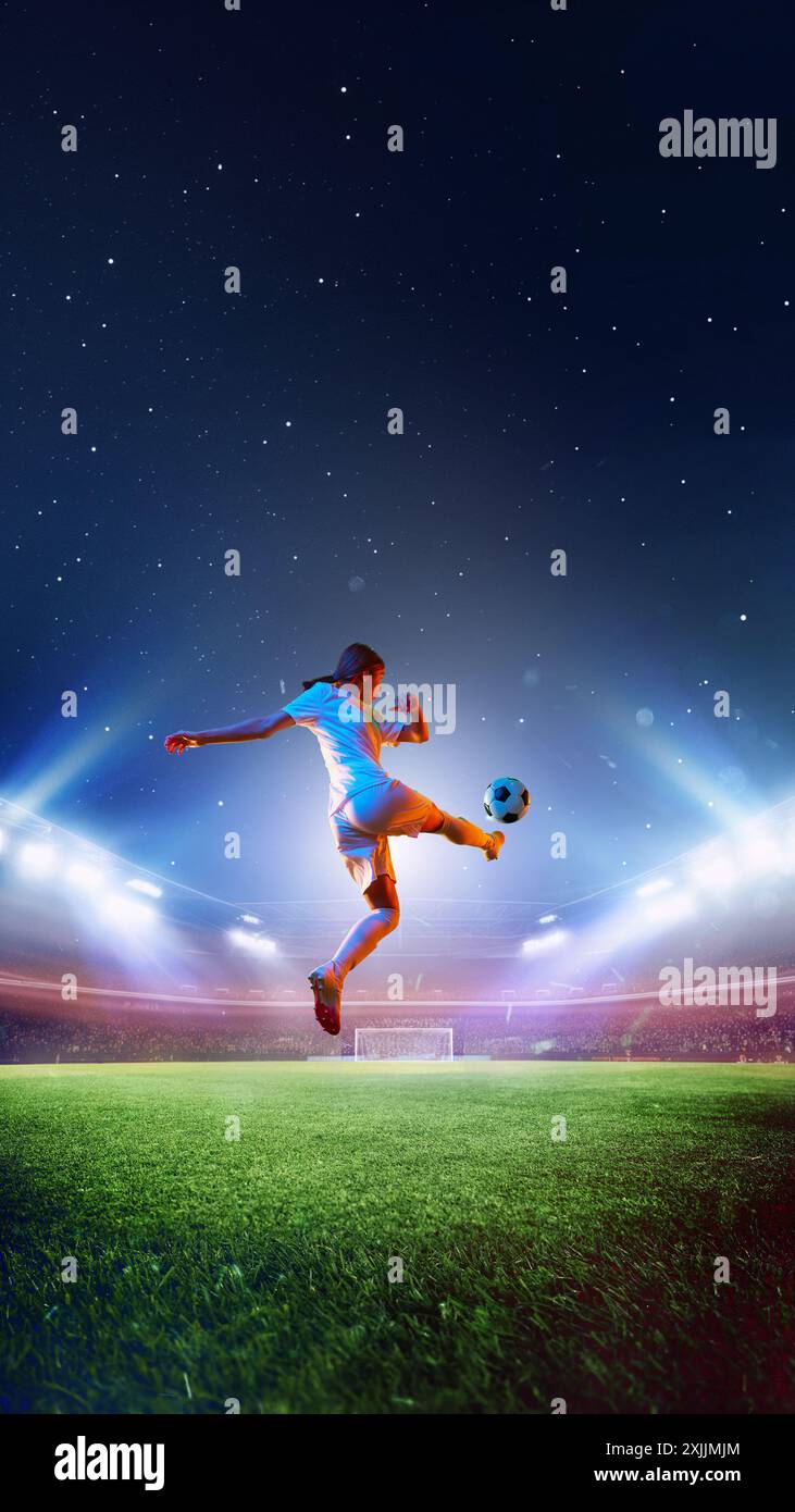 Female soccer athlete jumps to kick ball under starry night sky on ...