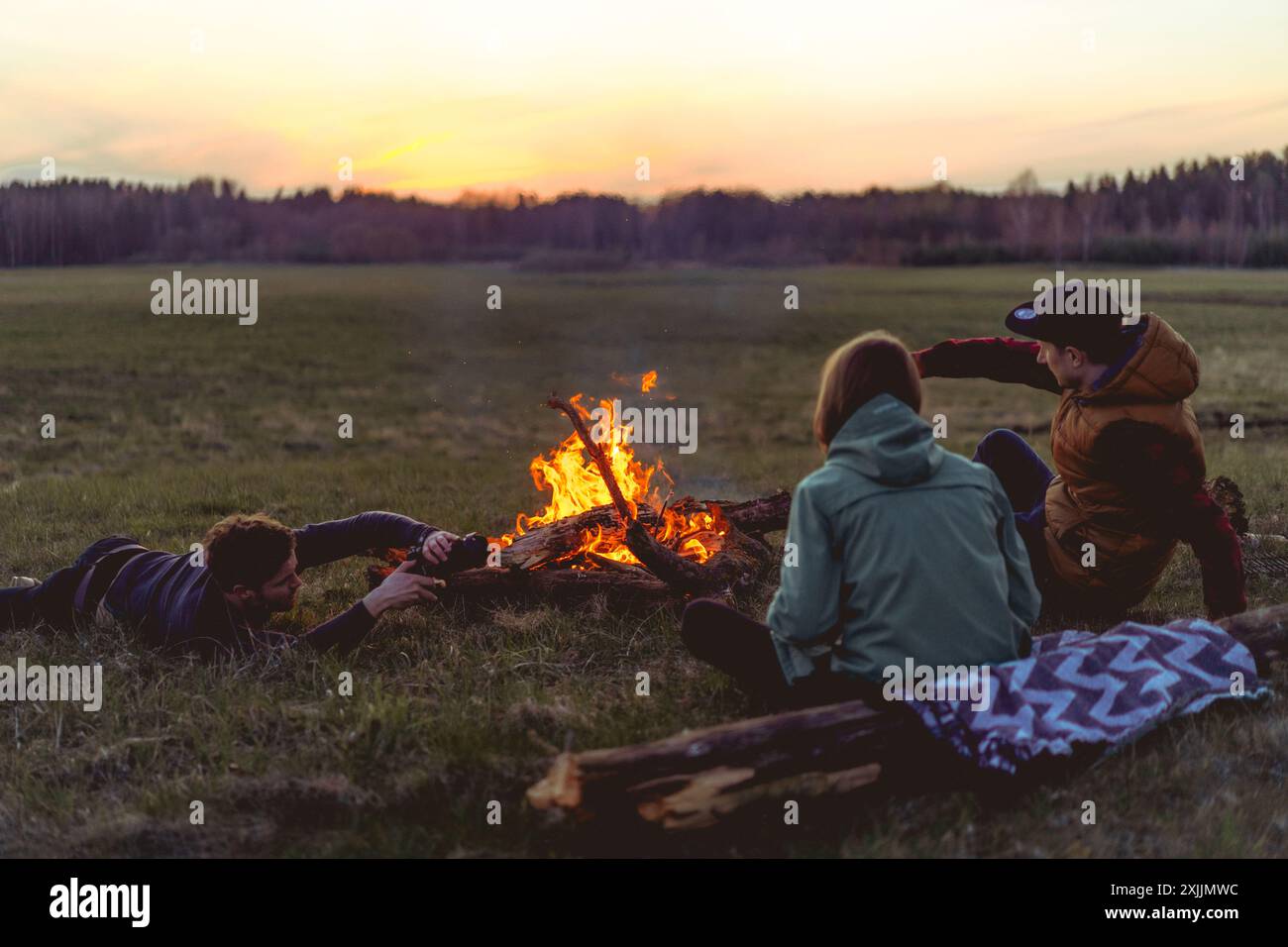 Group of friends on a picnic by the campfire Stock Photo - Alamy