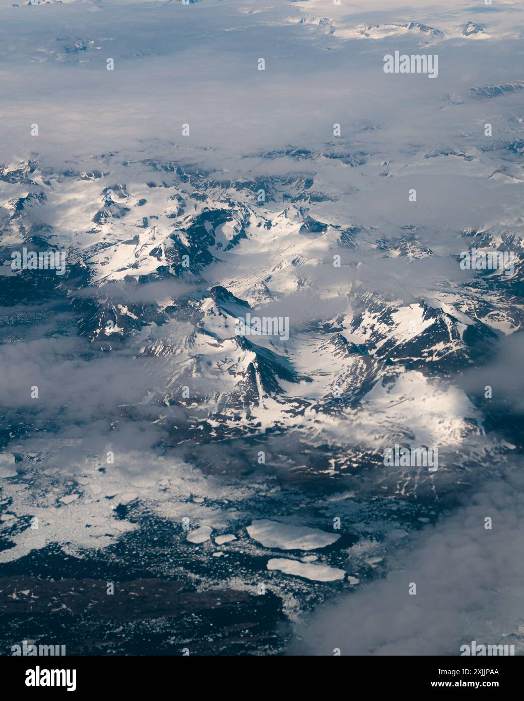 An aerial view above the snowy mountains of Greenland Stock Photo - Alamy