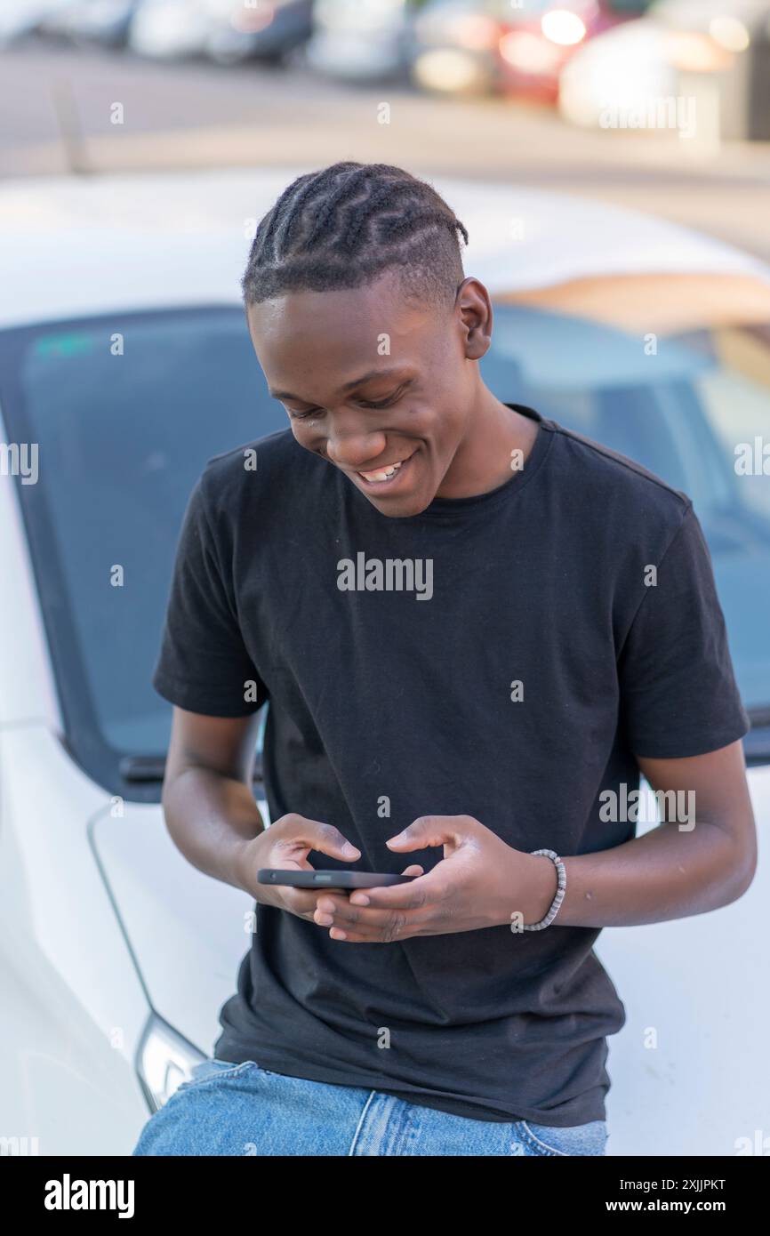young black man sending a message from his smartphone Stock Photo - Alamy