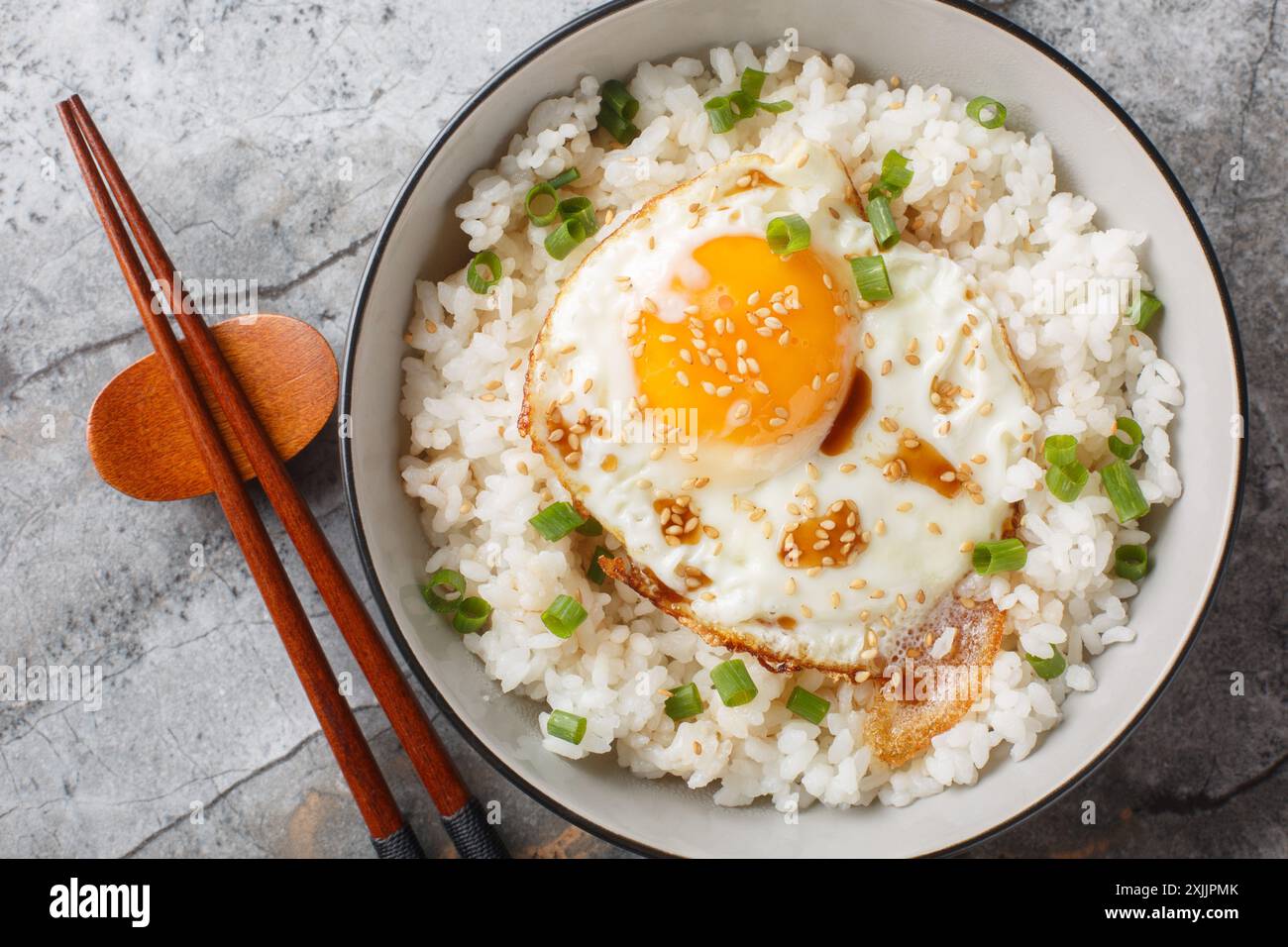 Homemade Asian Fried Egg and Rice Breakfast with Soy Sauce closeup on ...