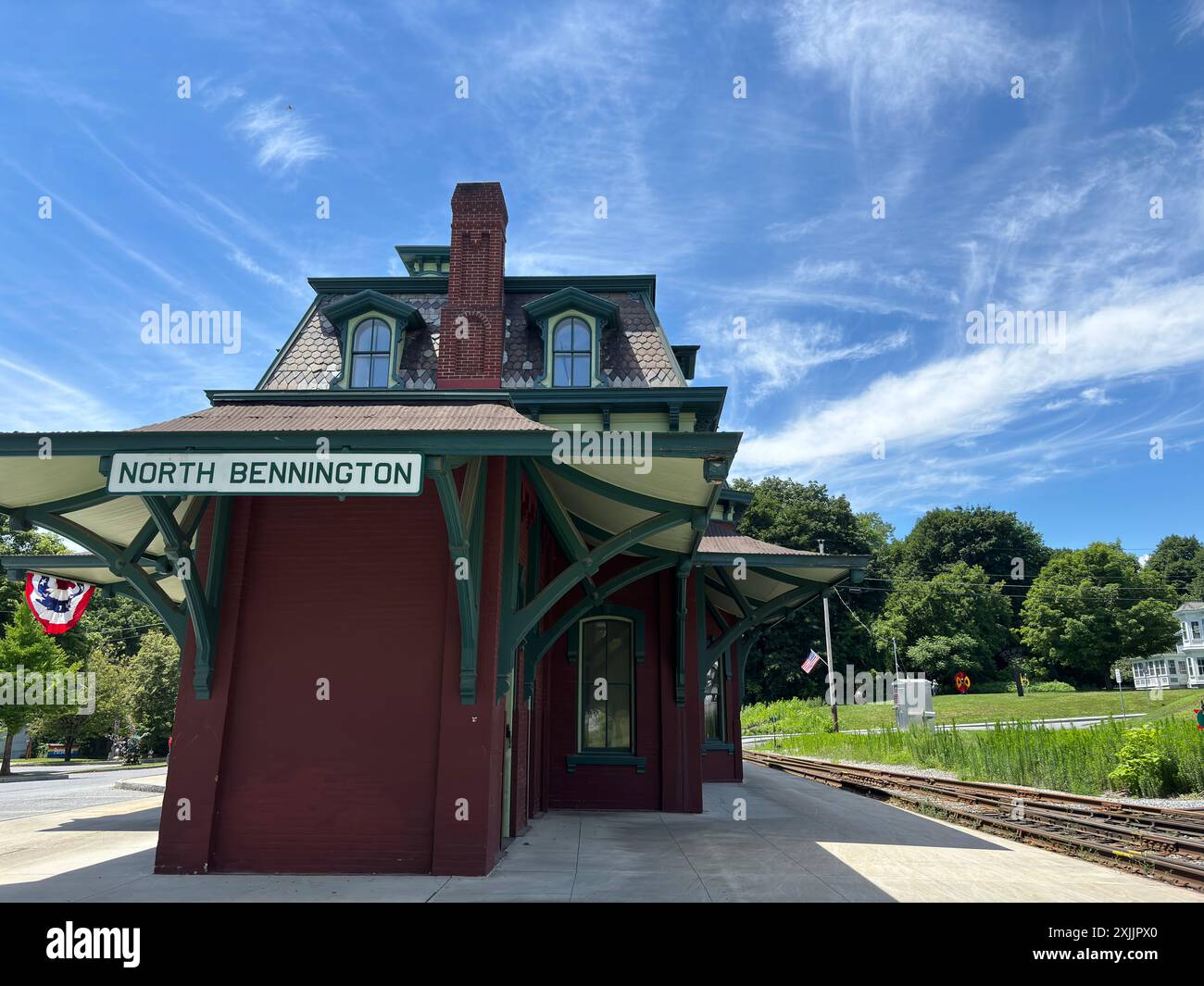 Red brick train station in North Bennington, VT with tracks, blue sky ...