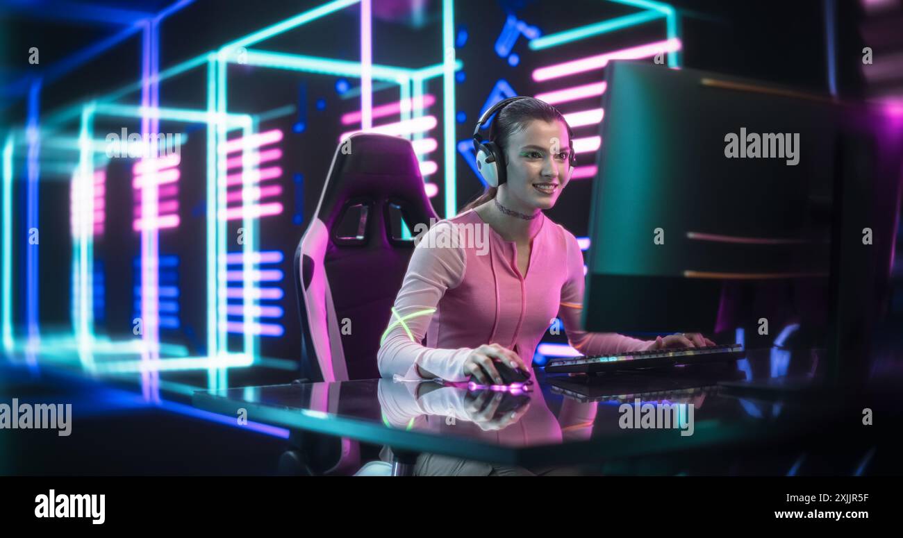 Female Gamer Sitting Behind a Futuristic Interactive Desk in a Colorful ...